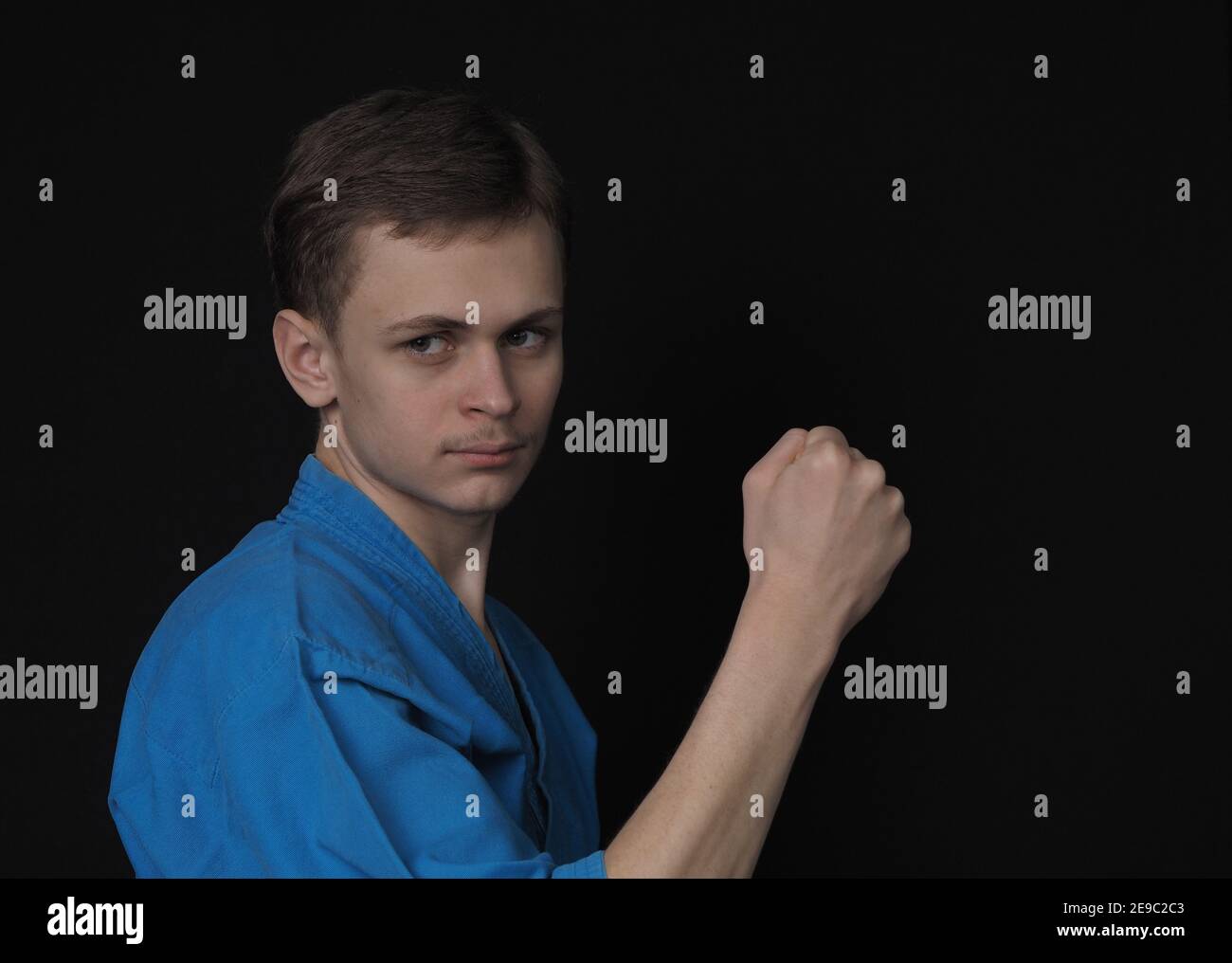 Portrait of a young man, an athlete of European appearance in a blue ...