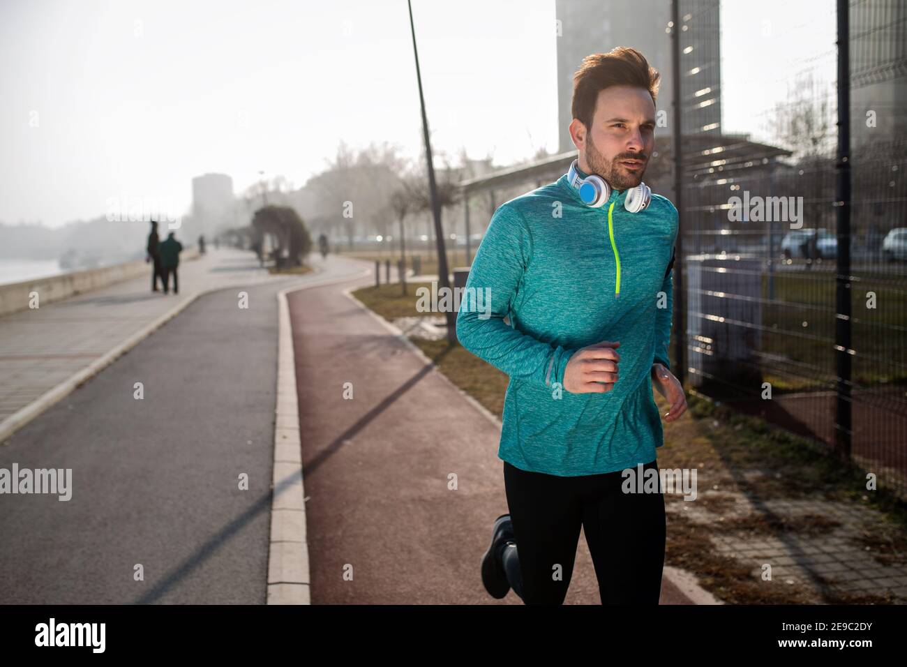 Young fitness man running in urban area Stock Photo - Alamy