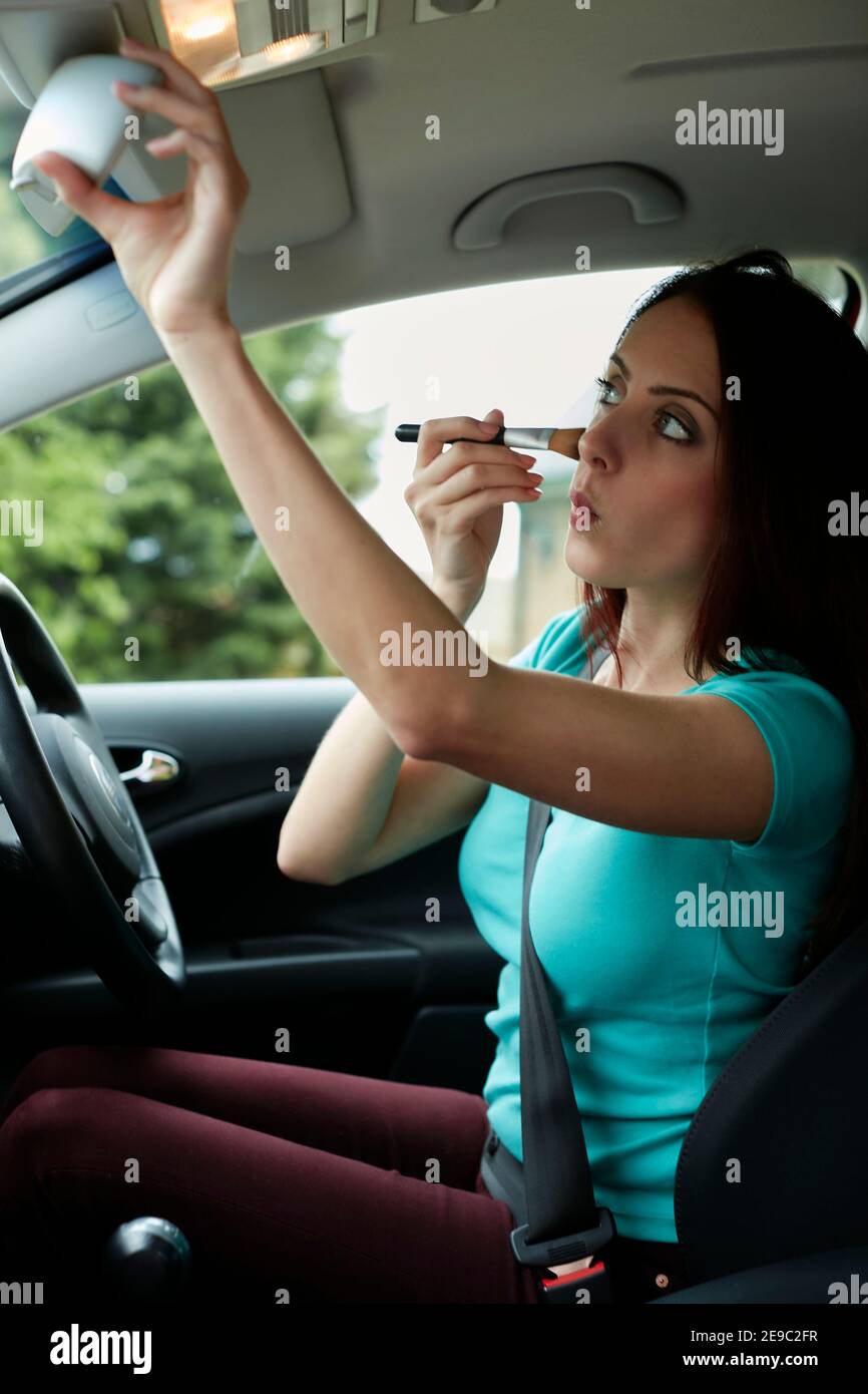 woman putting on make up in her car Stock Photo - Alamy