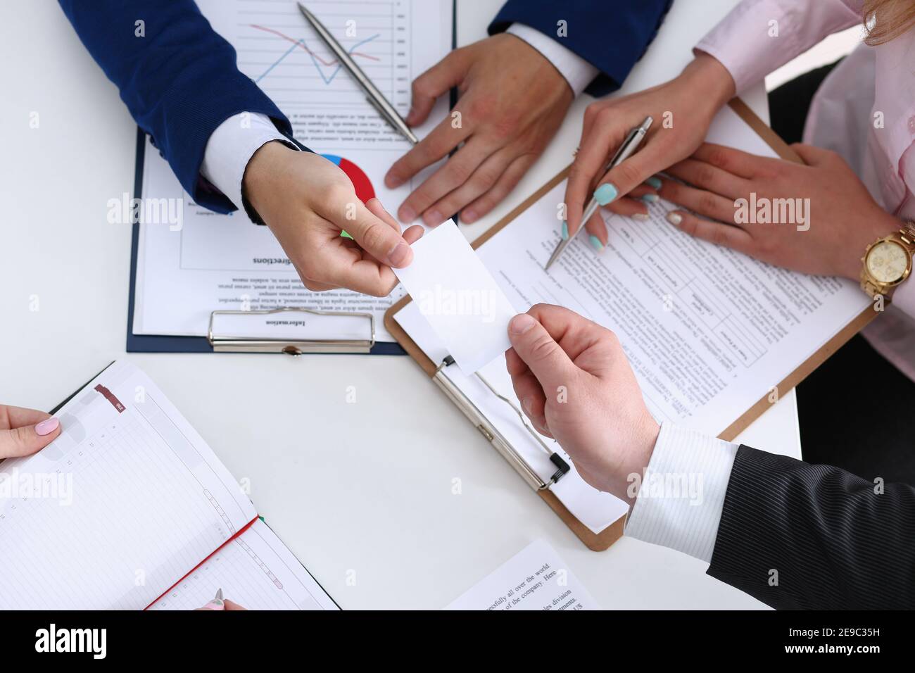 Group of people discuss plan at workplace closeup Stock Photo - Alamy
