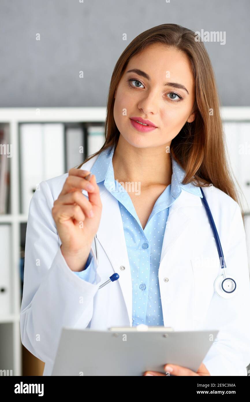 Beautiful female doctor hold in arm silver pen Stock Photo - Alamy