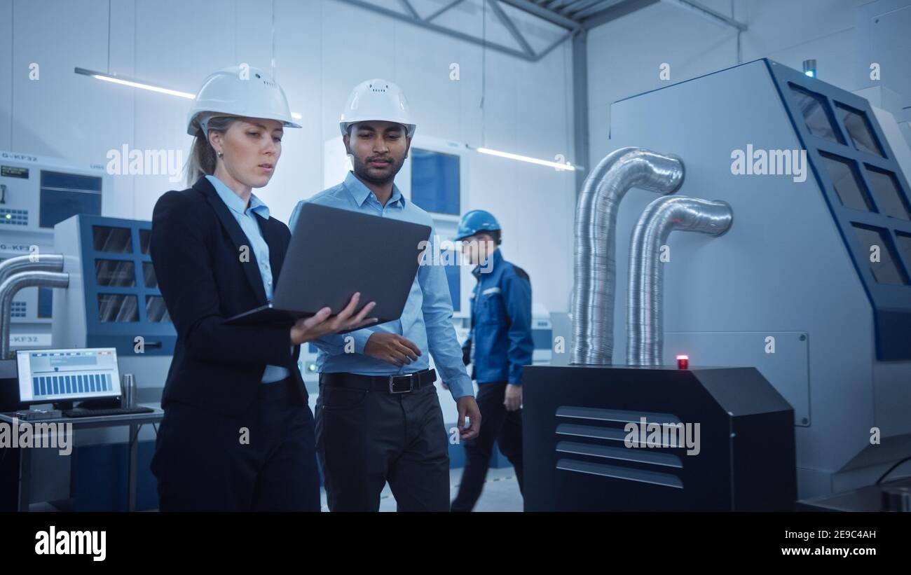 Female Chief Engineer and Male Project Manager Walk Through Modern ...