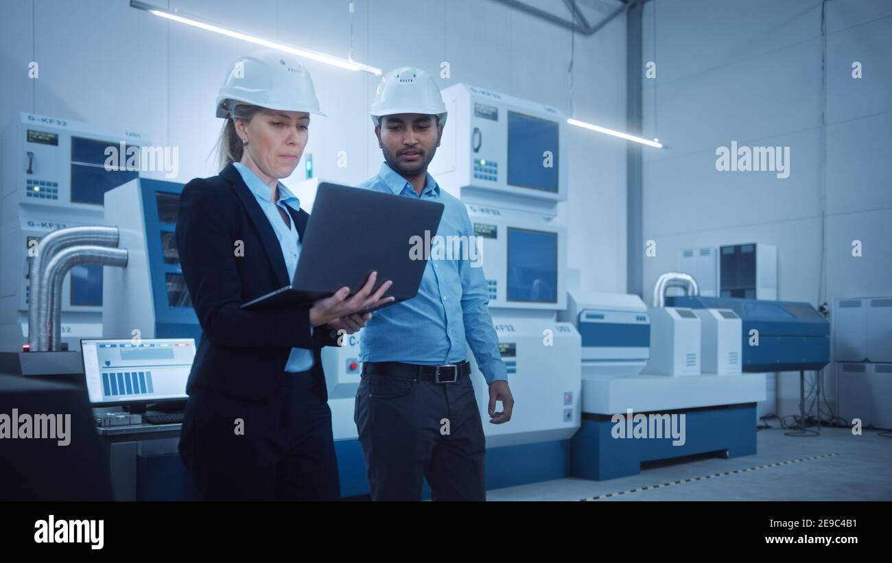 Female Chief Engineer and Male Project Manager Walk Through Modern ...