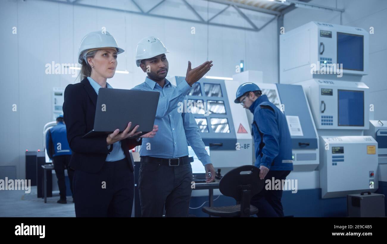 Female Chief Engineer and Male Project Manager Use Laptop in Modern ...