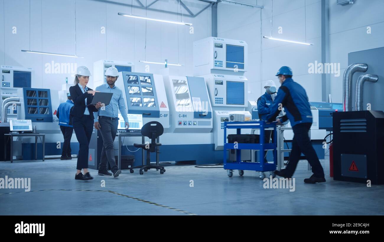 Female Chief Engineer and Male Project Manager Walk Through Modern ...