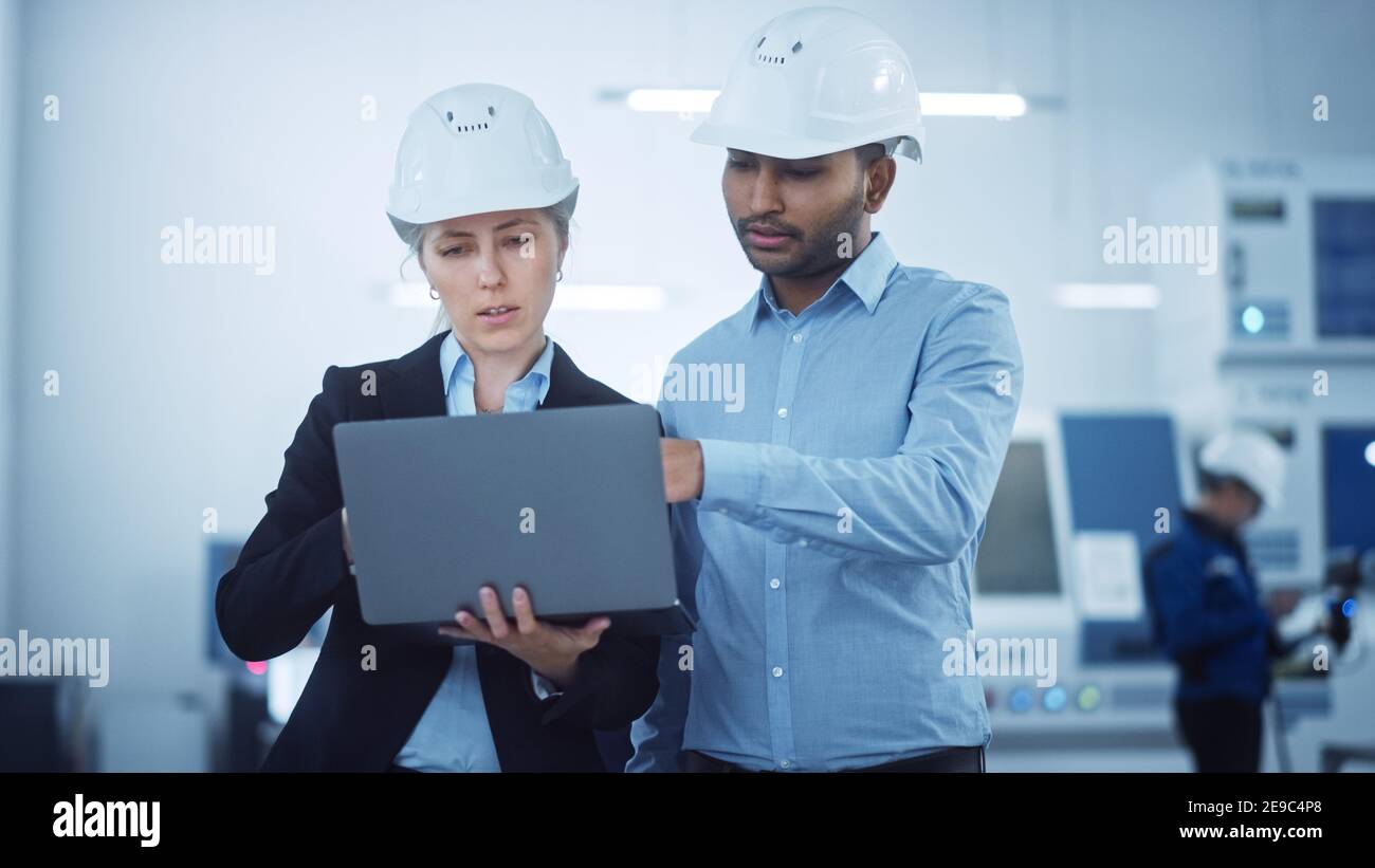 Female Chief Engineer and Male Project Managers Standing in the Middle ...