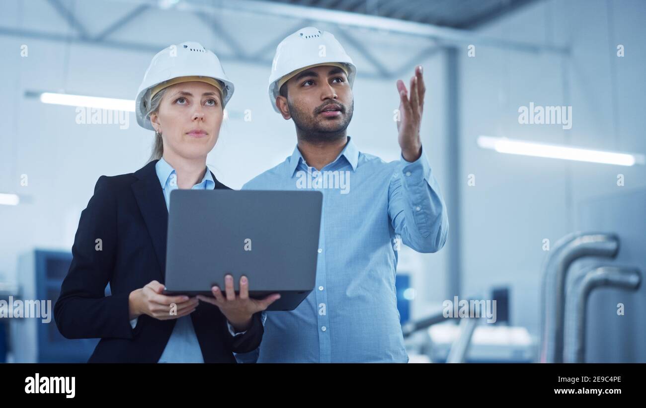 Female Chief Engineer and Male Project Managers Standing in the Middle ...