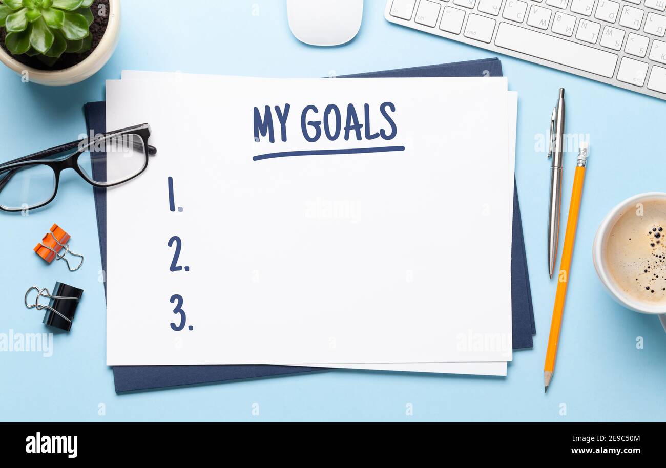 Office workplace table with goals list template, supplies and computer ...