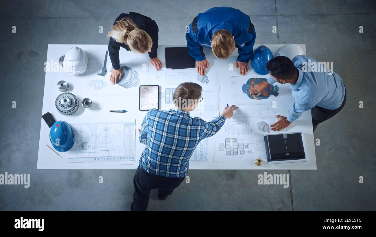 Team of Industrial Engineers Lean on Office Table, Analyze Machinery ...