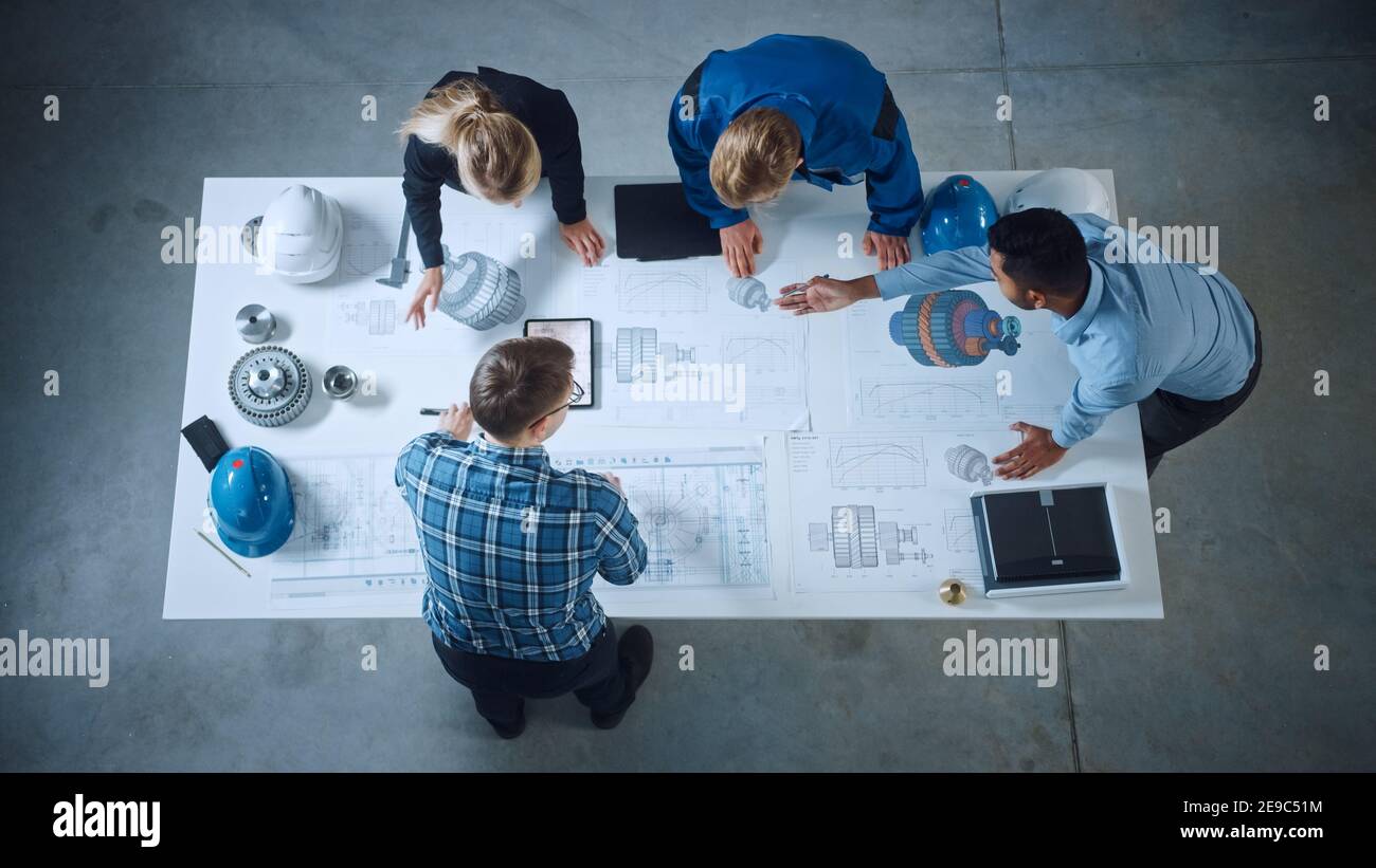 Team of Industrial Engineers Lean on Office Table, Analyze Machinery ...