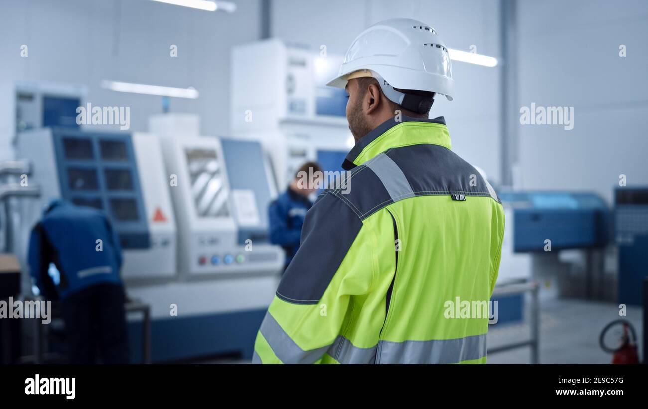 Industry 4 Factory: Modern Worker Wearing Safety Jacket and Hard Hat ...