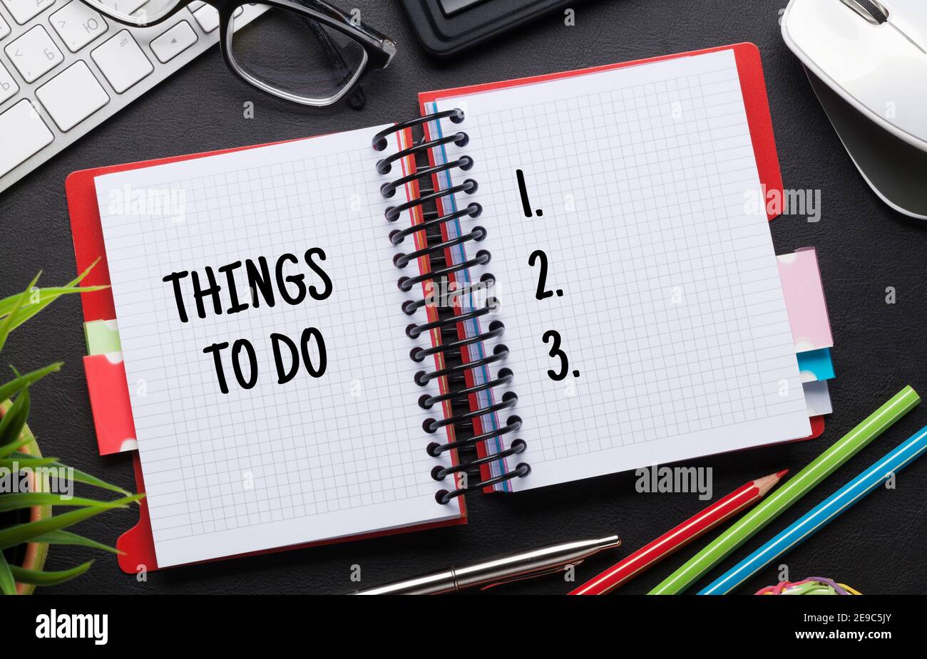 Office desk with to do list notepad, computer and supplies. Top view ...