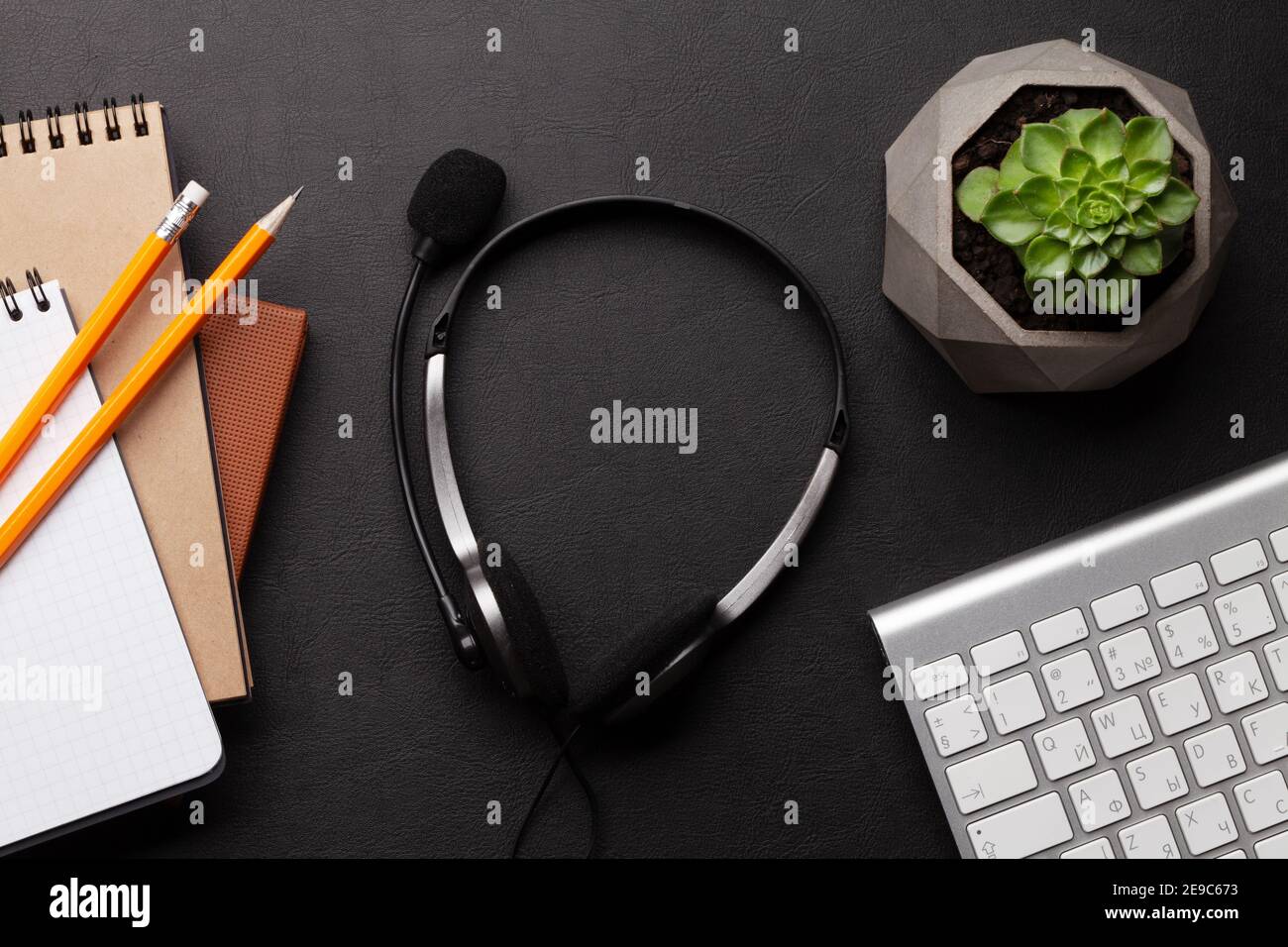 Office desk with headset and supplies. Remote office and work from home ...