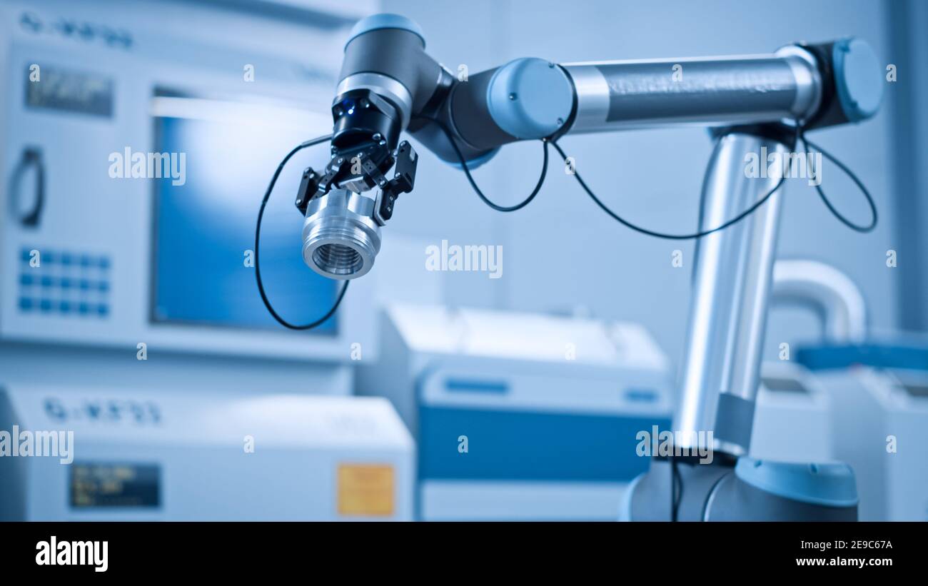 Industry 4.0 Modern Factory: Programmed robot arm Packing Metal ...