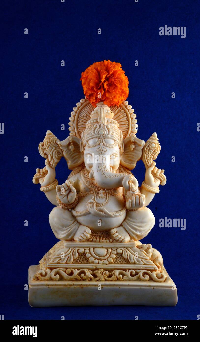 Hindu God Ganesha. Ganesha Idol on blue background Stock Photo - Alamy