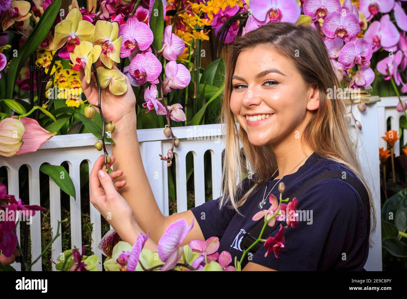 Kew Gardens Orchid Festival, staff member with beautiful orchids at the ...