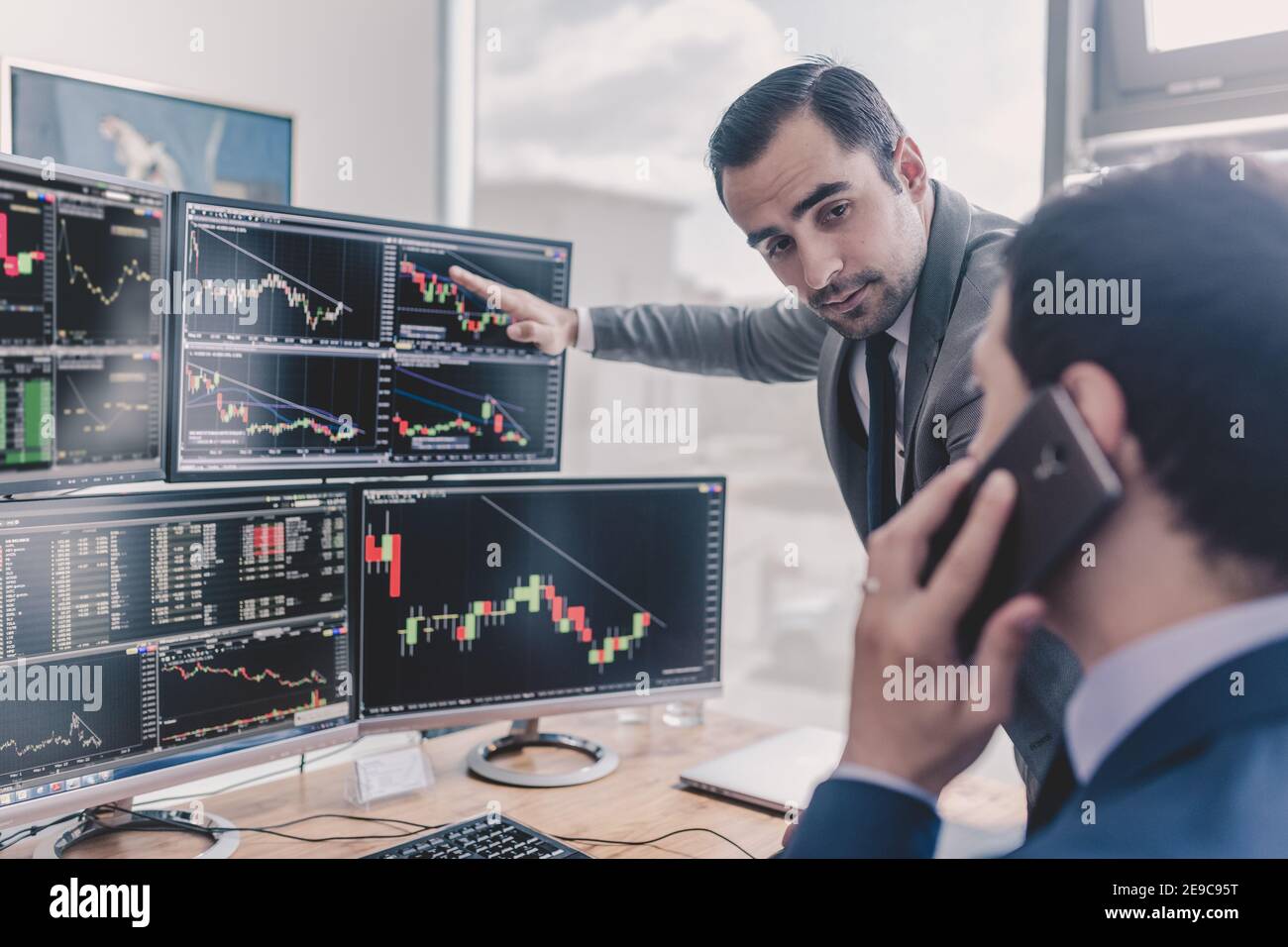 Stock brokers looking at computer screens, trading online Stock Photo ...