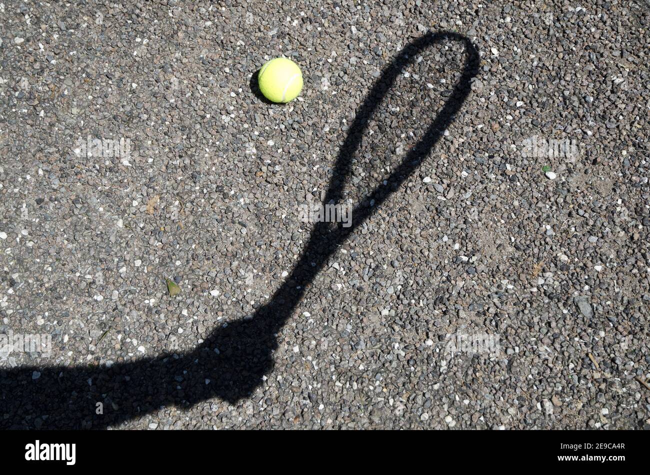 Shadow Playing Tennis with Racket and ball on the Gravel Stock Photo ...