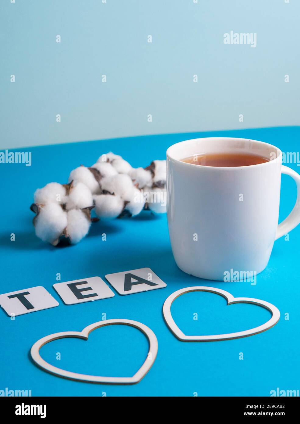 selective focus: Ceylon black tea in a white mug on a blue plain paper ...