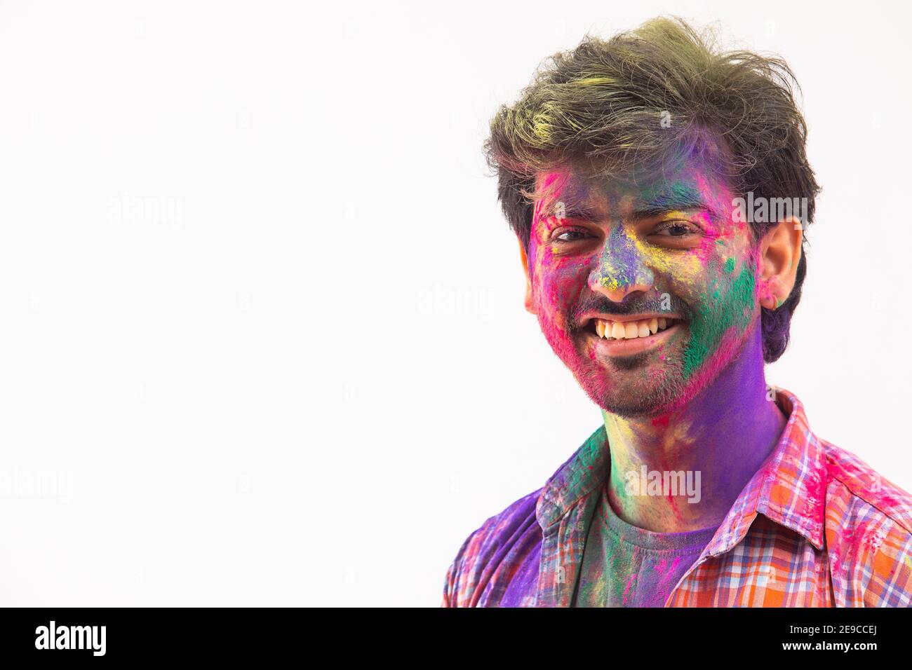 PORTRAIT OF A YOUNG MAN WITH HOLI COLOURS ALL OVER HIS FACE Stock Photo ...