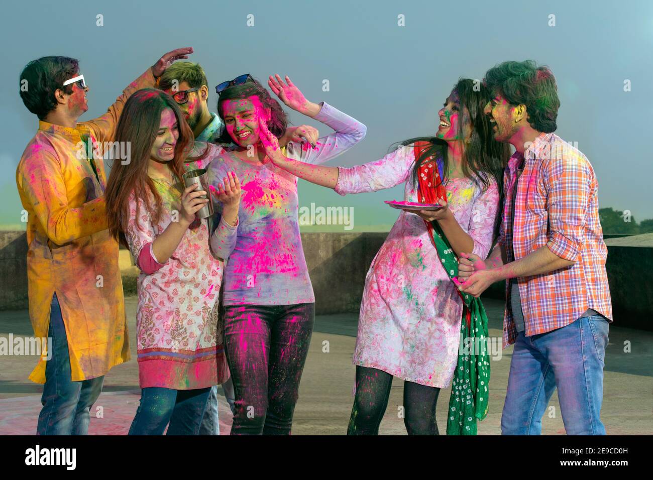 A GROUP OF FRIENDS CELEBRATING HOLI TOGETHER WITH GULAL AND BHANG Stock ...