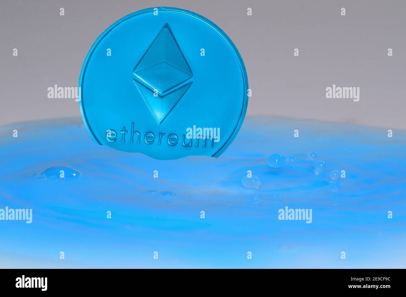 blue ether coin in a blue fluid with drops and grey background Stock ...