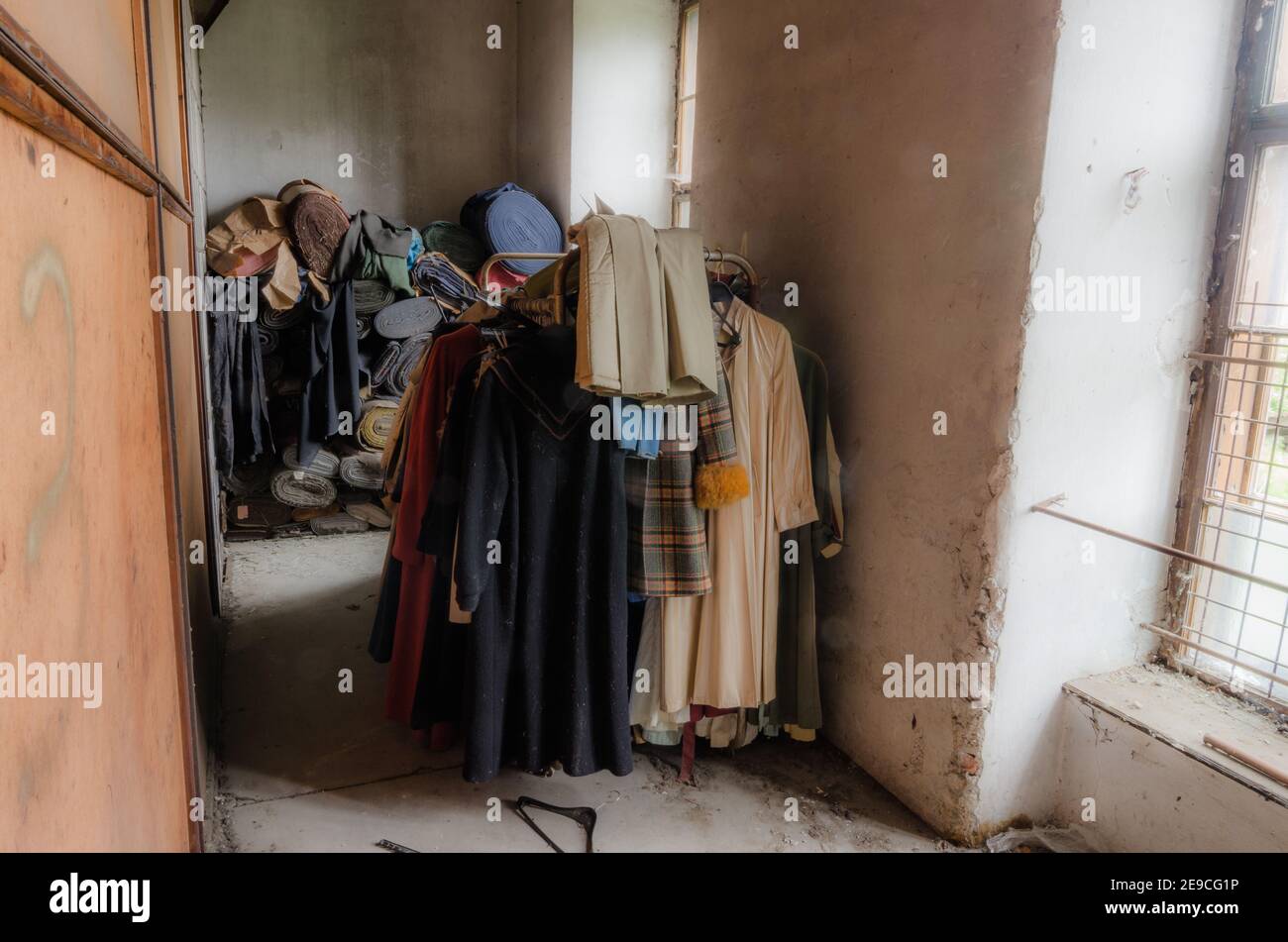 old clothing collection in abandoned textile factory Stock Photo - Alamy