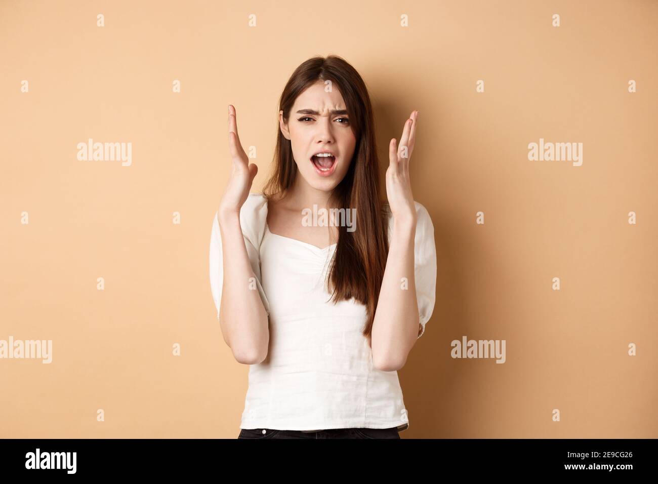 Frustarted woman shouting and shaking hands angry, looking mad ...