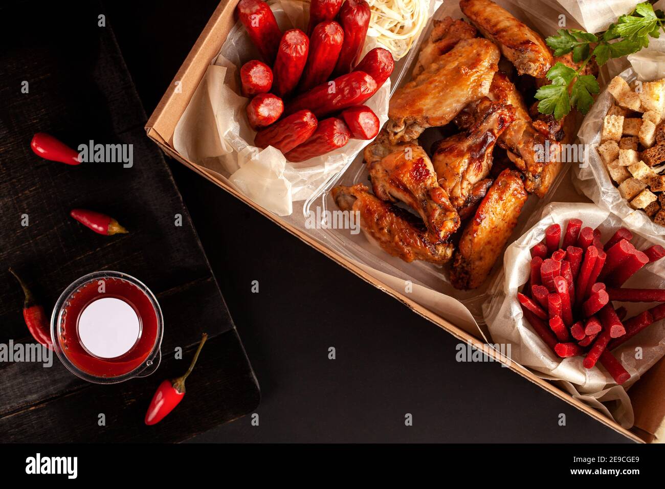 Red peppers on a black background in a low key. Food delivery from ...