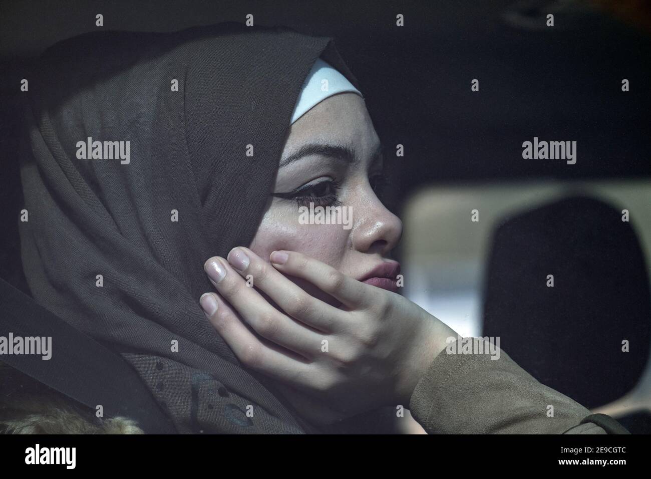 A Palestinian woman wearing a hijab rides a bus in the West Bank Israel ...