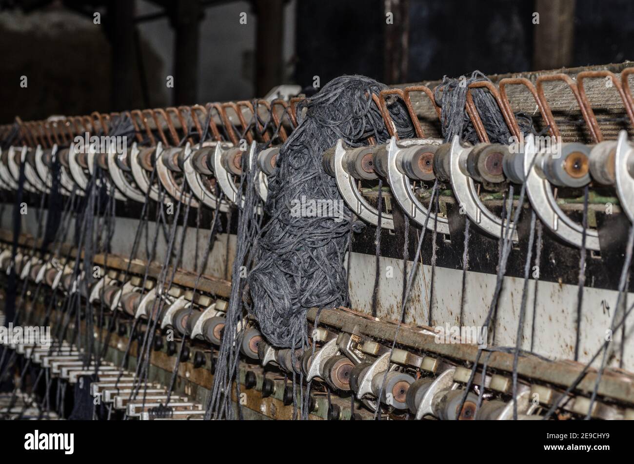 gray yarn at a machine in a spinning factory Stock Photo - Alamy