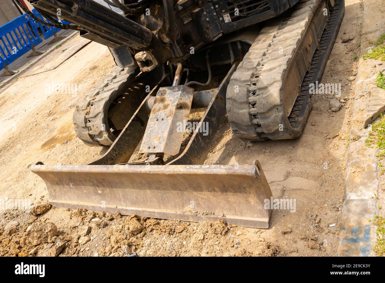 one bulldozer working on the road in urban area Stock Photo - Alamy