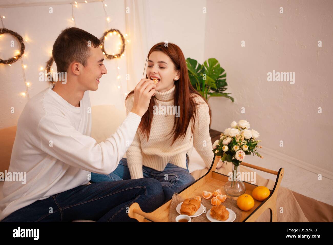 Couple feeding each other and holiday hi-res stock photography and ...
