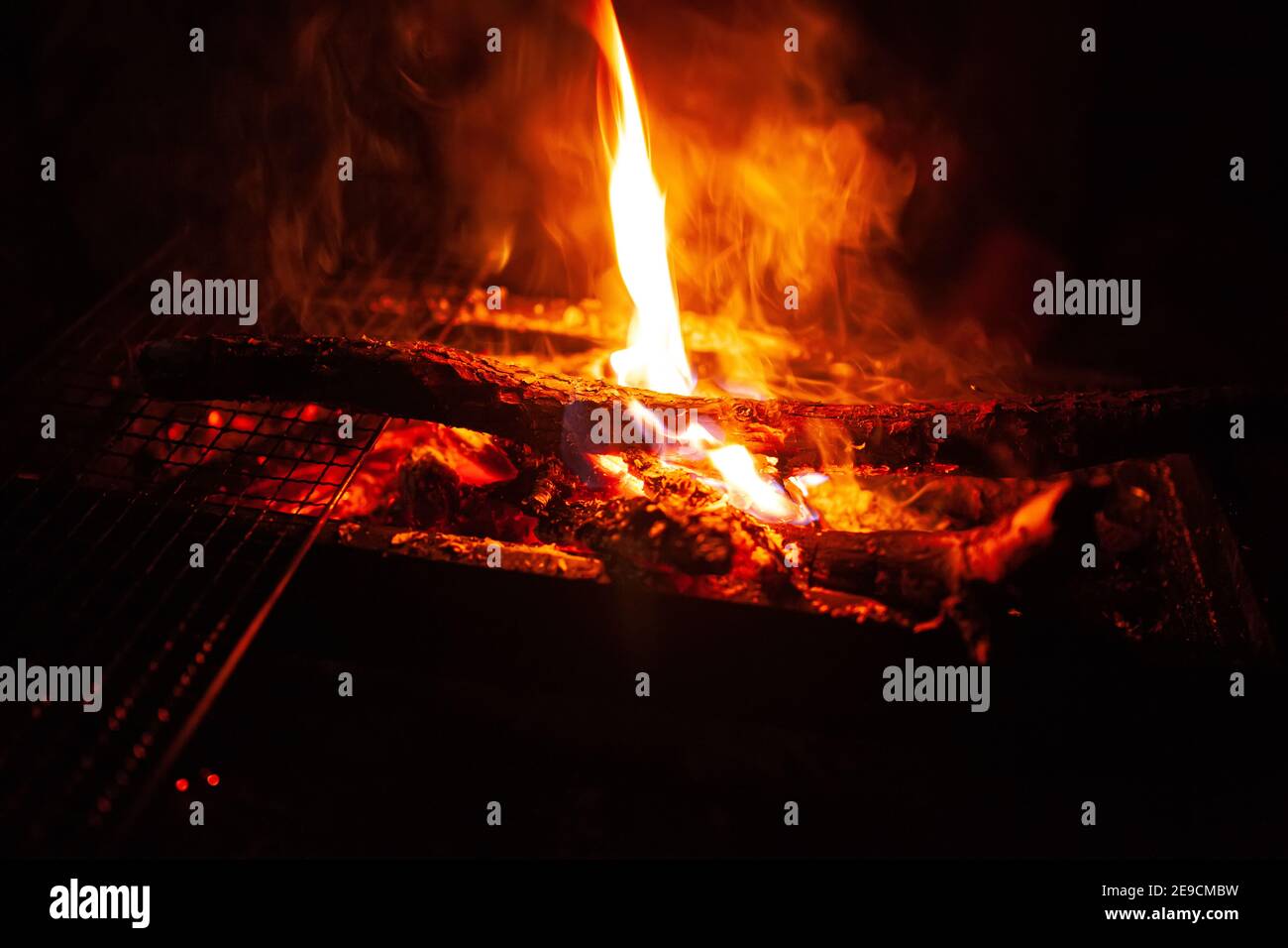 Sparking bonfire with tourist people sit around bright bonfire near ...
