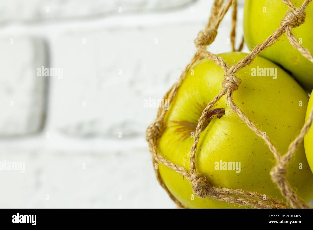 Ripe green apples in a light string bag Stock Photo - Alamy