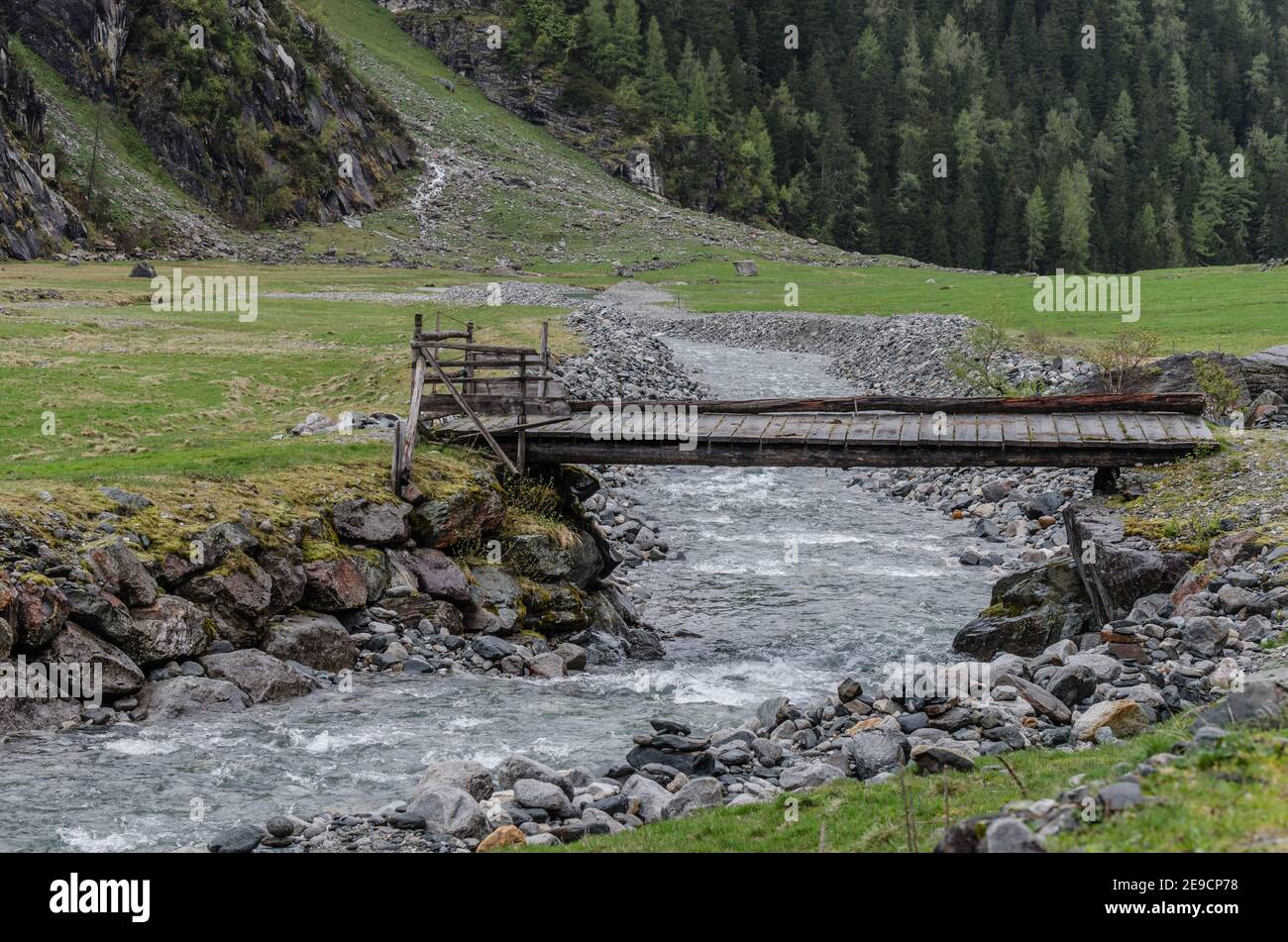 Wooden bridge over creek in the mountains Stock Photo - Alamy