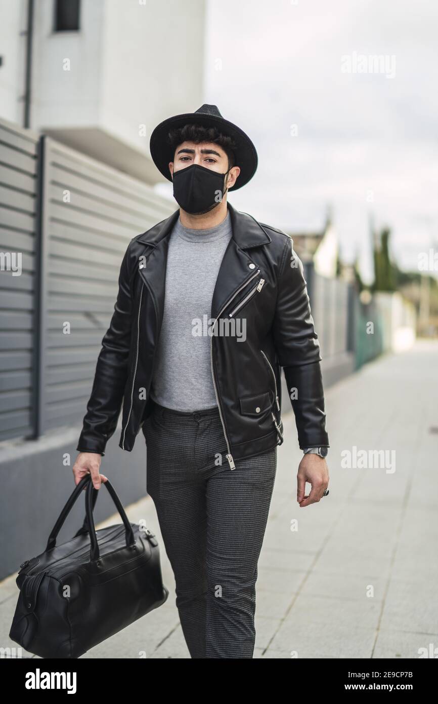 Shallow focus shot of a European male wearing a protective mask to ...