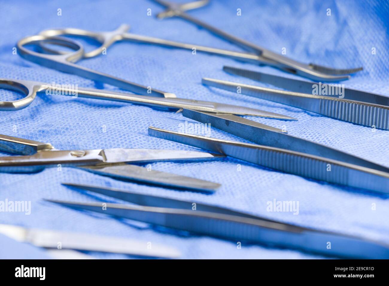 Closeup of a dissection kit on a blue surface under the lights Stock ...