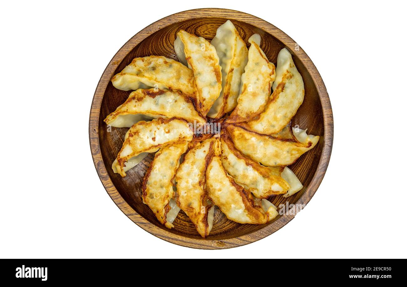 Asian dinner : Fried japanese gyoza dumplings on wooden bowl isolated ...