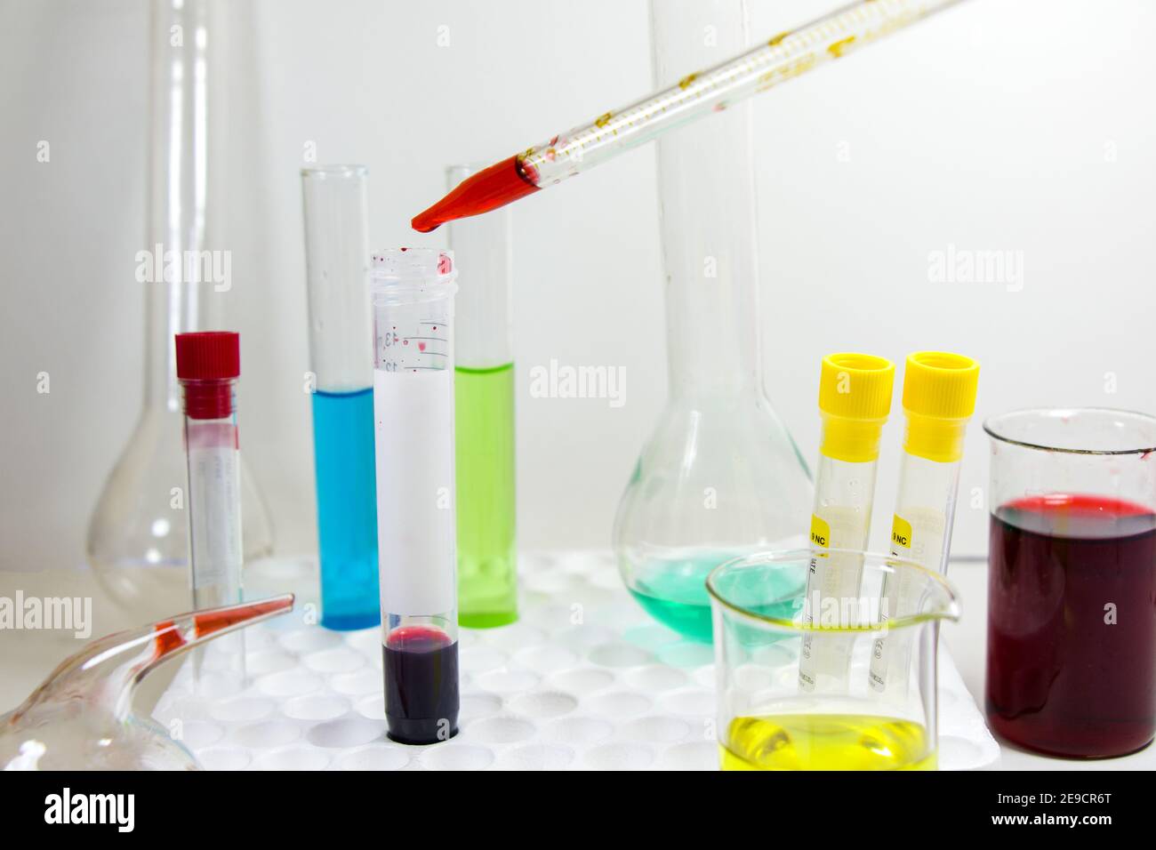 Chemist pouring substance flask hi-res stock photography and images - Alamy