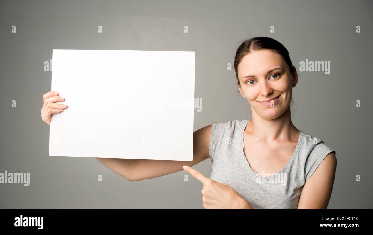 woman holding a sheet of paper in her hand Stock Photo - Alamy