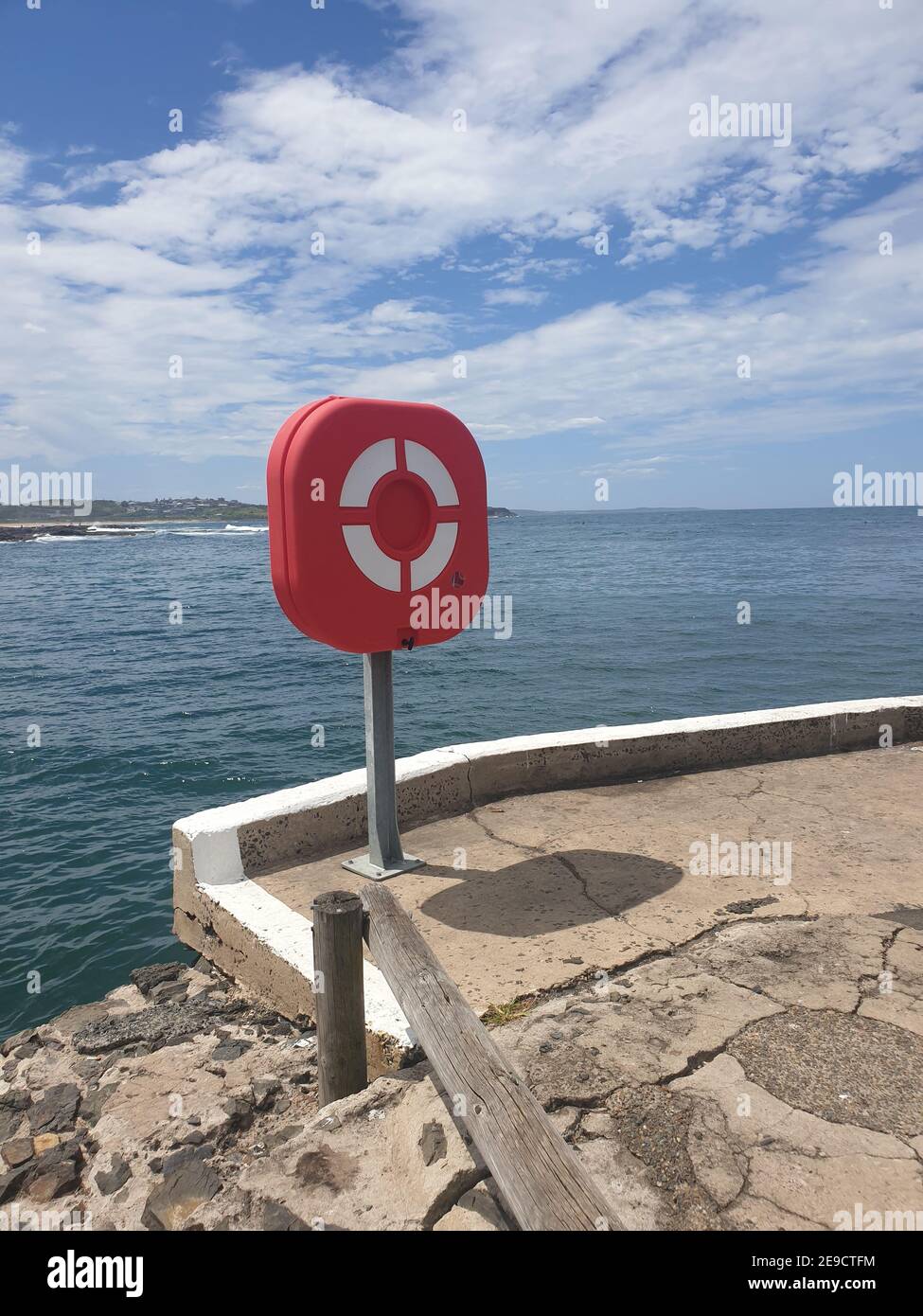 Vertical shot of a red lifeguard ring post in Kiama South Coast ...