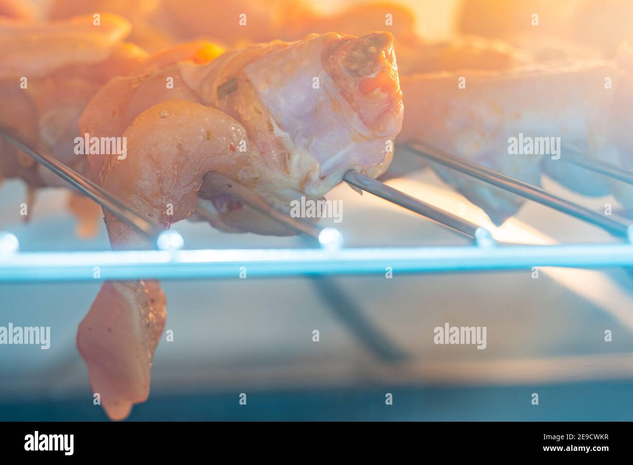 Close up photo of baking raw chicken wings on the rack inside oven ...