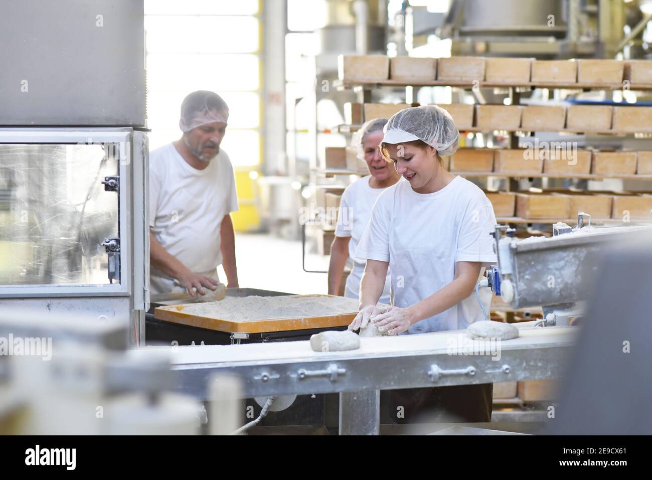 Worker in a large bakery - industrial production of bakery products on ...