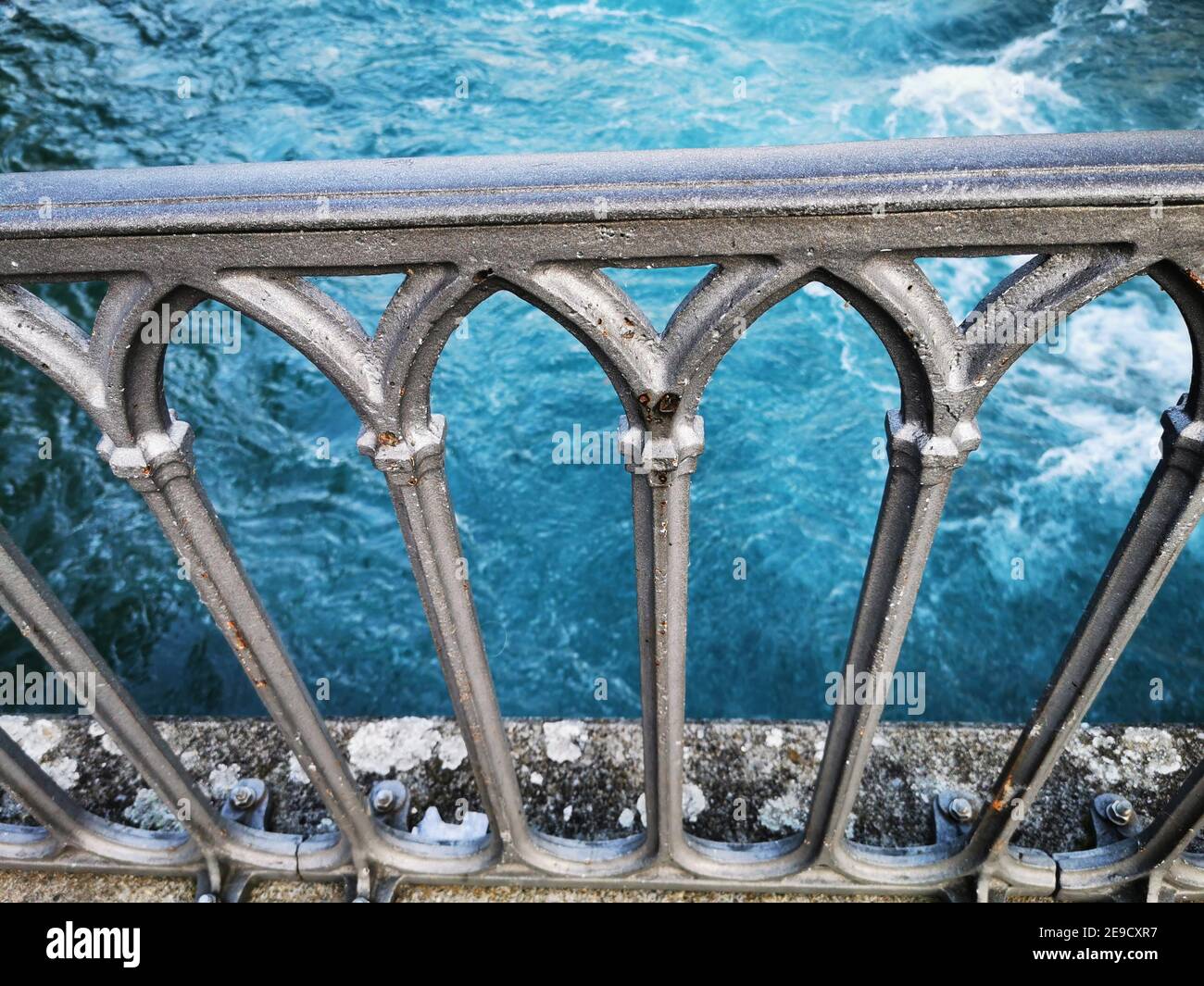 High angle shot of metal railings with a water background Stock Photo ...
