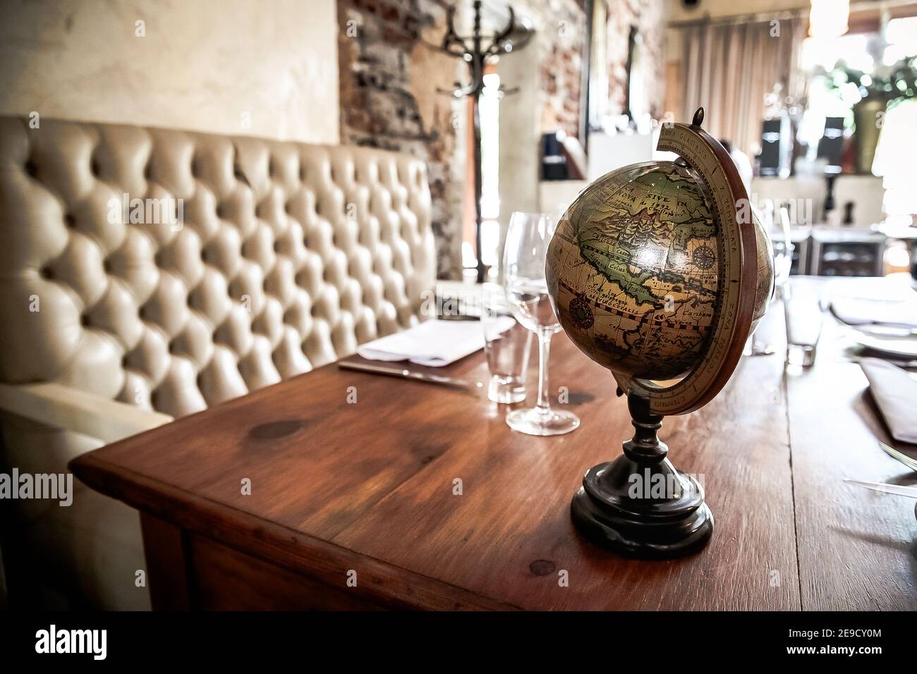 Interior of a fancy restaurant with leather seats and a vintage globe ...