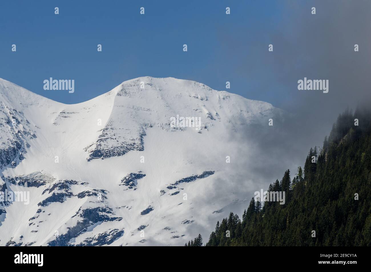high mountain with snow and fog Stock Photo - Alamy
