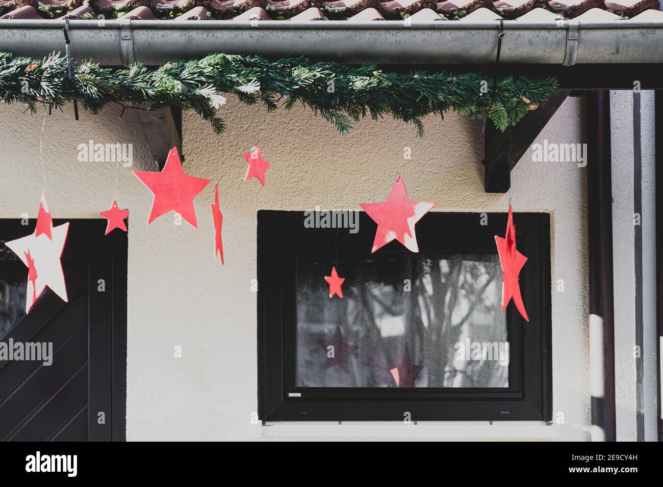 Red paper stars hanging outside the house for Christmas decorat Stock ...