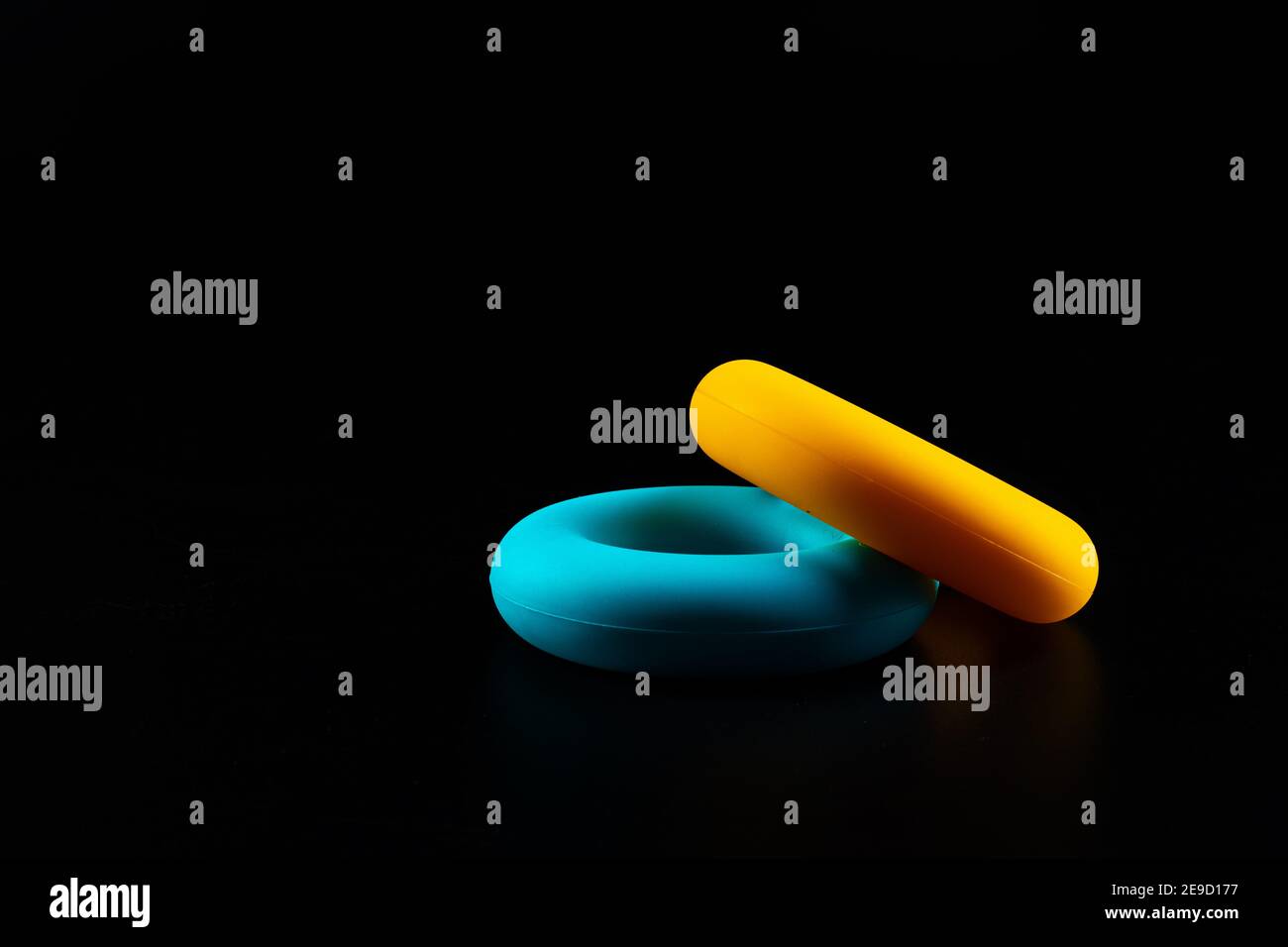 Two round rubber expander on black background Stock Photo - Alamy