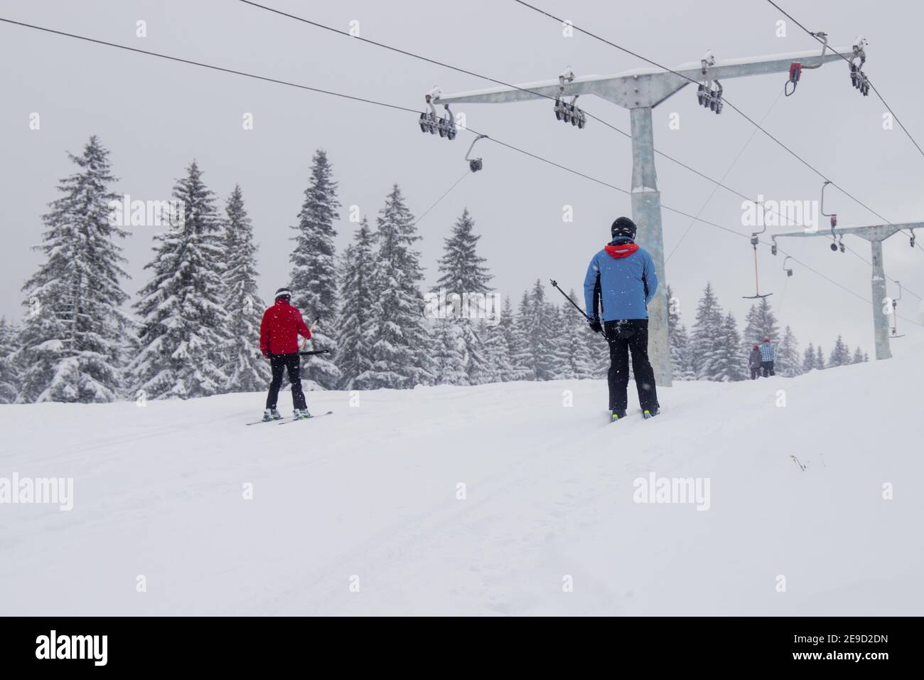 Chilling view of skiers on the mountain during winter Stock Photo - Alamy